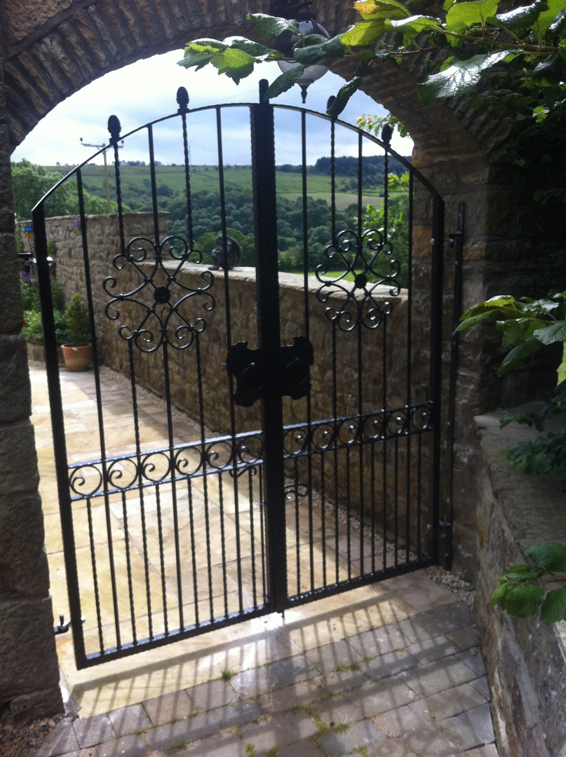 Ornate arched gate with matching rails, Haydon Bridge, Northumberland ...